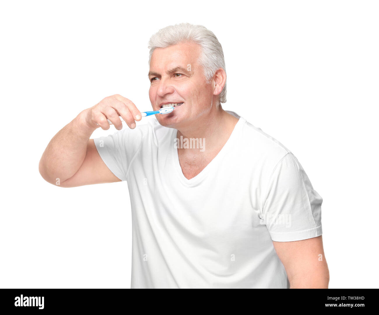 Senior man cleaning teeth on white background Stock Photo - Alamy