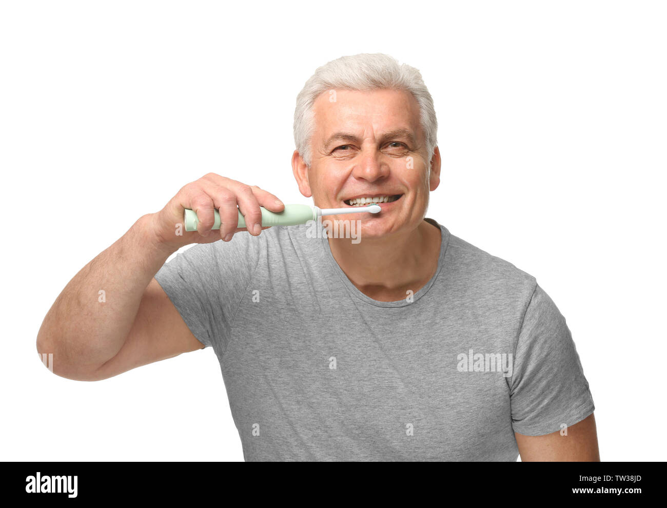 Senior man cleaning teeth on white background Stock Photo - Alamy