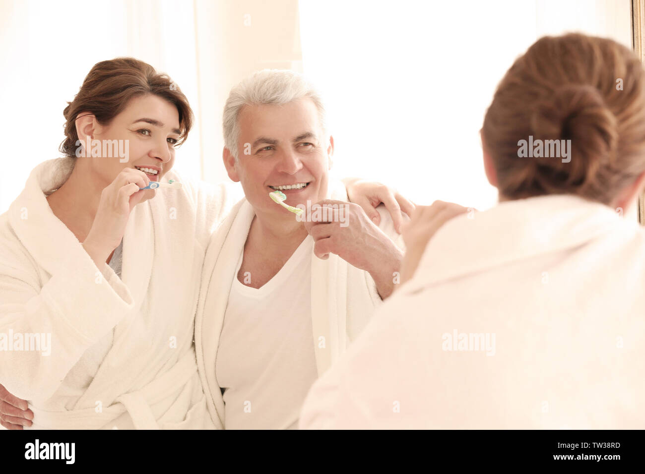 Senior couple cleaning teeth at home Stock Photo - Alamy