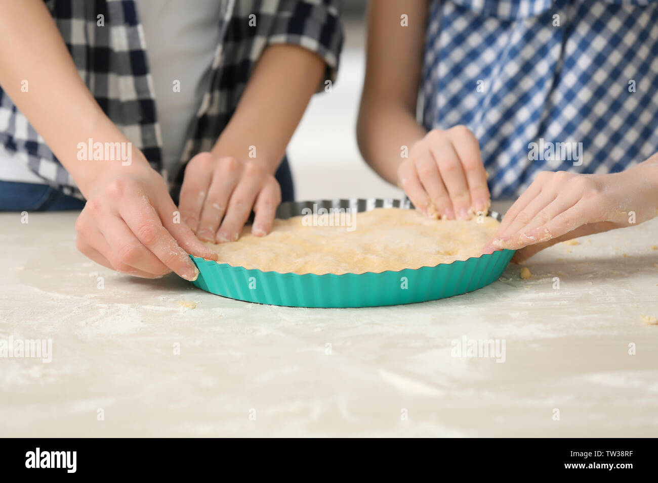 Mother and daughter cooking pie in kitchen Stock Photo - Alamy