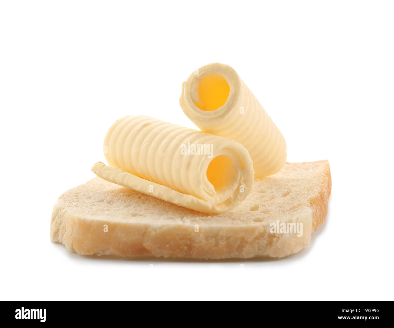Slice of bread with butter curls on white background Stock Photo - Alamy