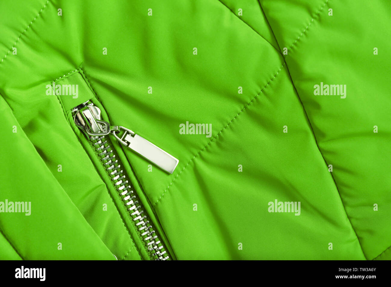 Green cloth with zipper, closeup Stock Photo - Alamy
