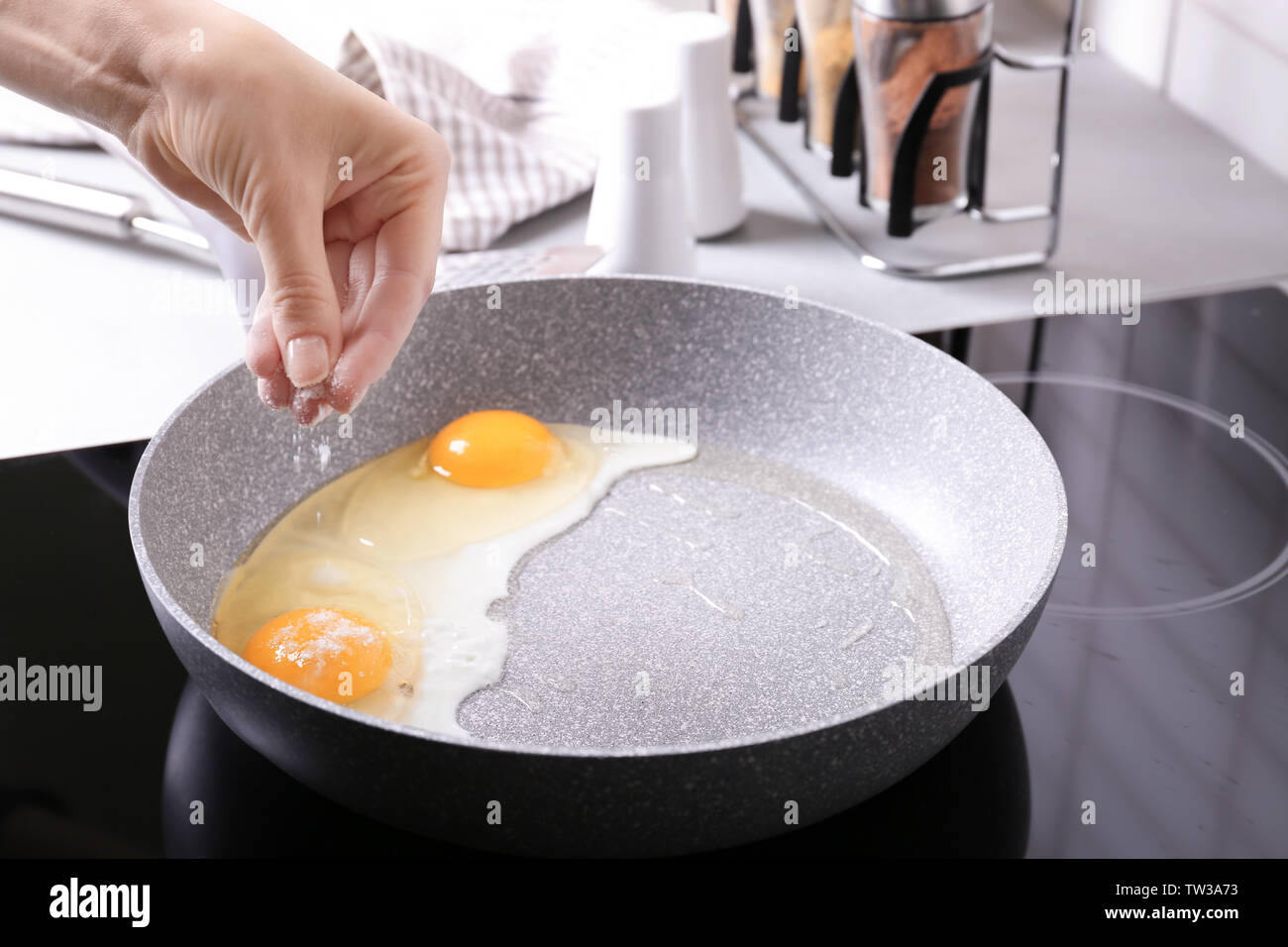 Woman adding salt to food in restaurant hi-res stock photography and ...