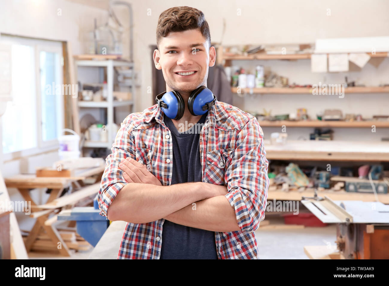 Handsome young carpenter in workshop Stock Photo - Alamy