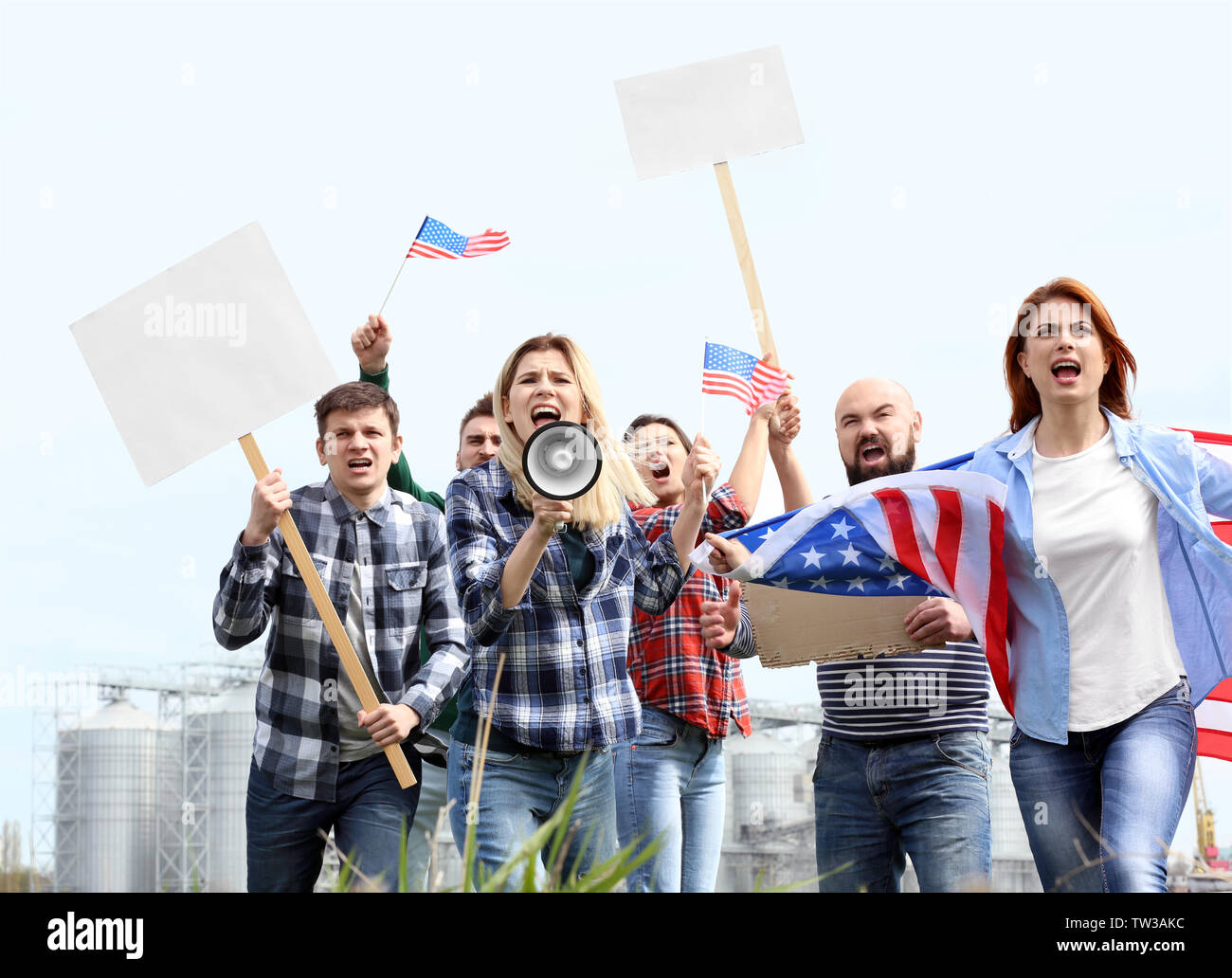 Group of protesting young people with American flag on street Stock ...