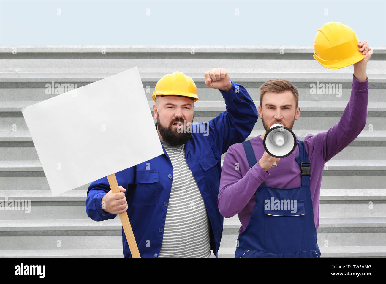 Protesting young men and fence on background Stock Photo - Alamy