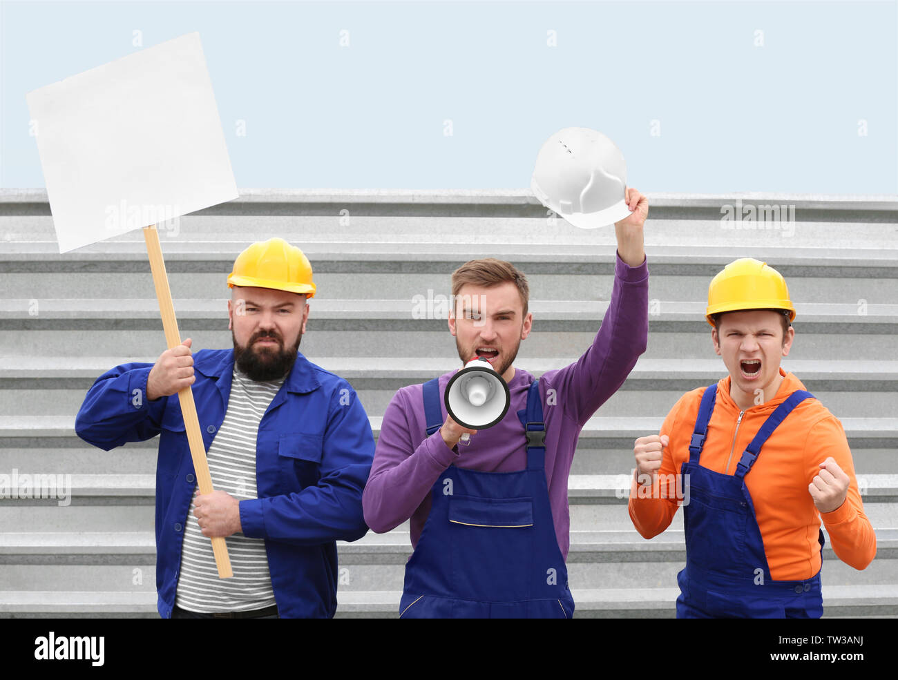 Group of protesting young men and fence on background Stock Photo - Alamy