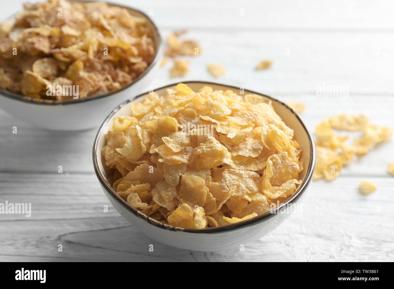 Bowls with different healthy cornflakes on wooden background Stock ...