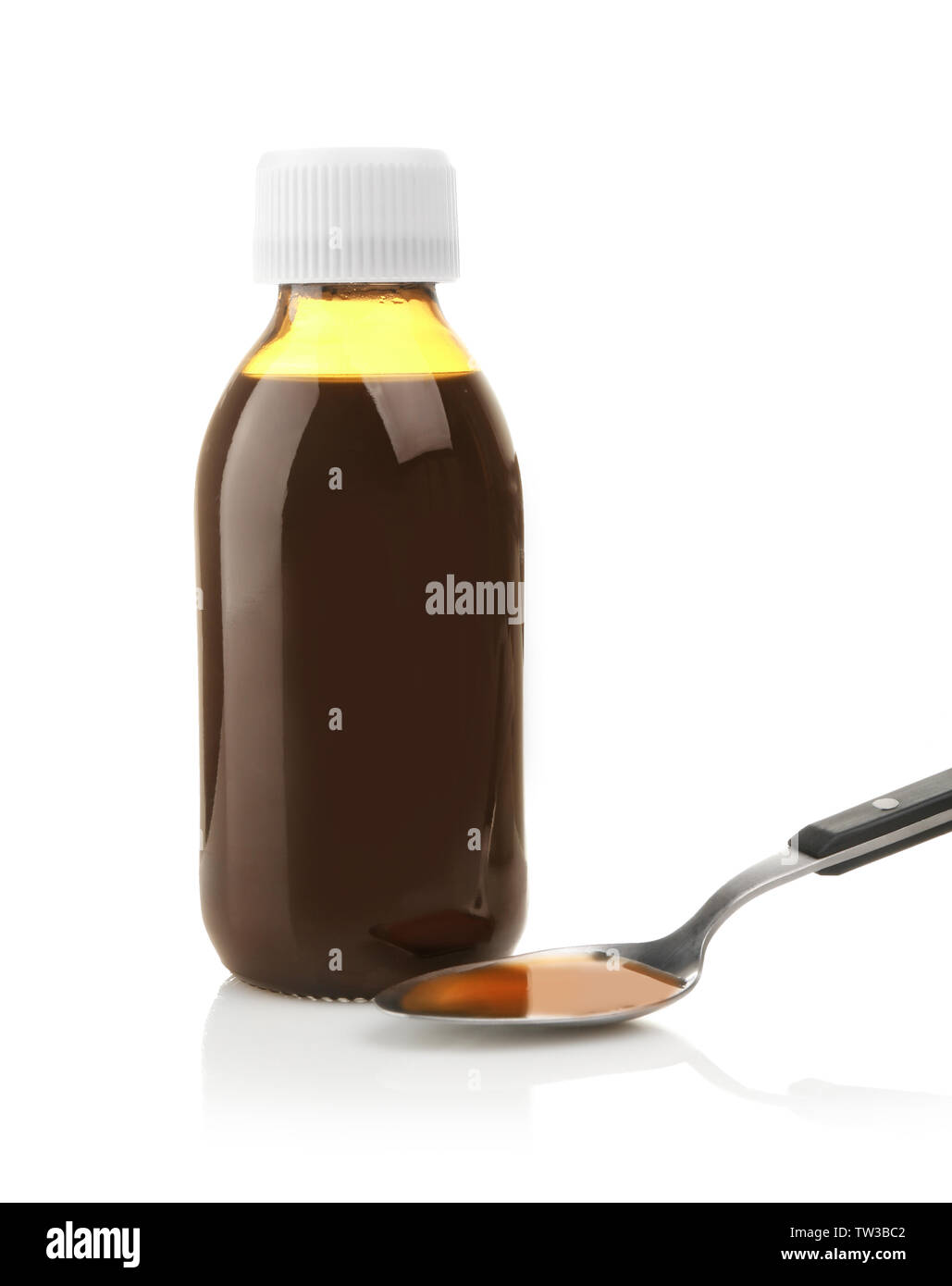 Bottle with cough syrup and poured dose in spoon on white background ...