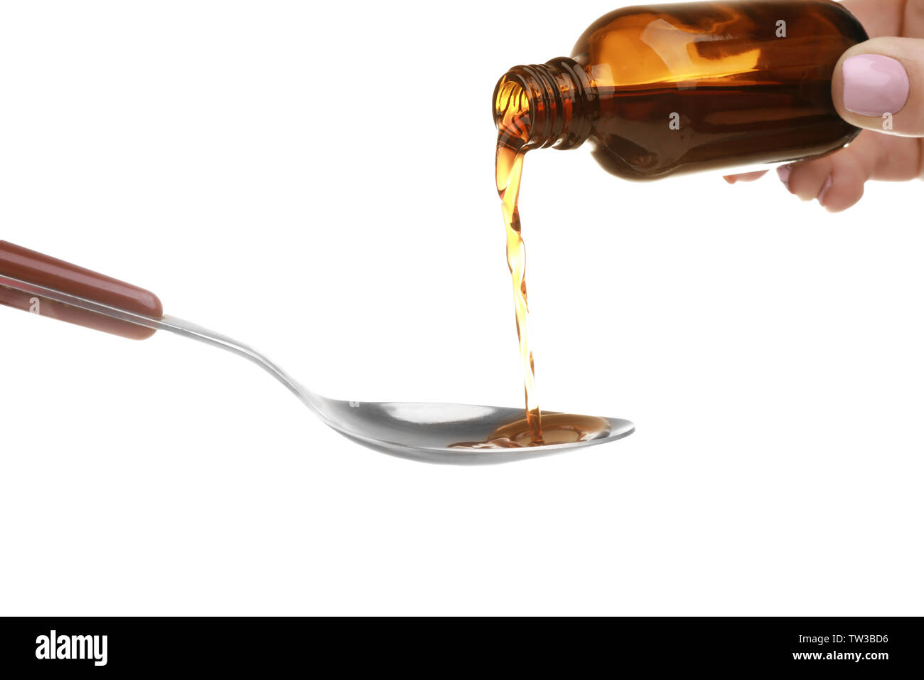 Pouring cough syrup into spoon on white background Stock Photo - Alamy