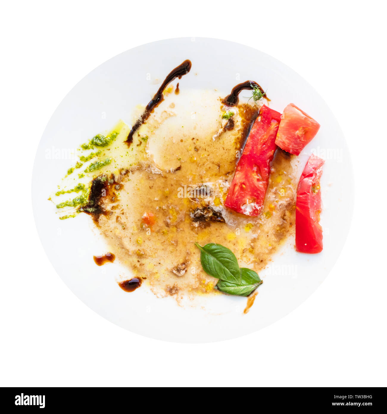 top view of white plate with leftover vegetables and dressing after ...