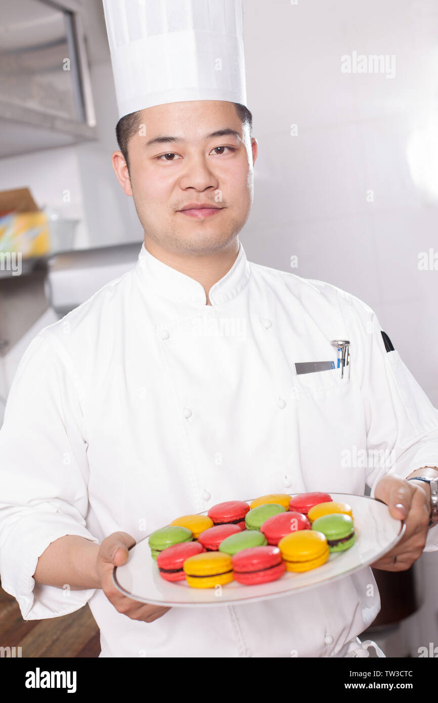young chinese man chelf making food in modern kitchen Stock Photo - Alamy