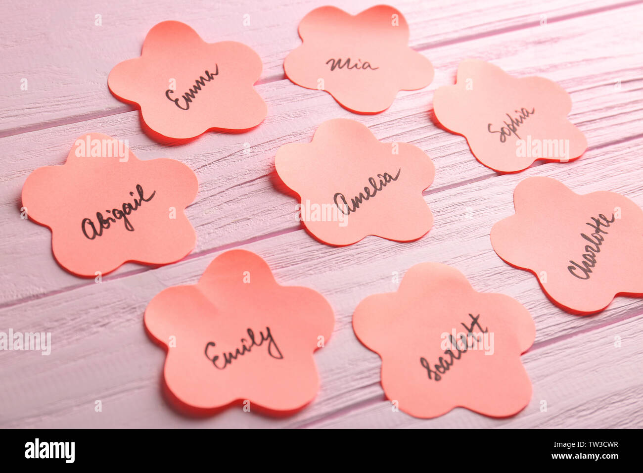 Paper stickers with different names on wooden background. Concept of ...