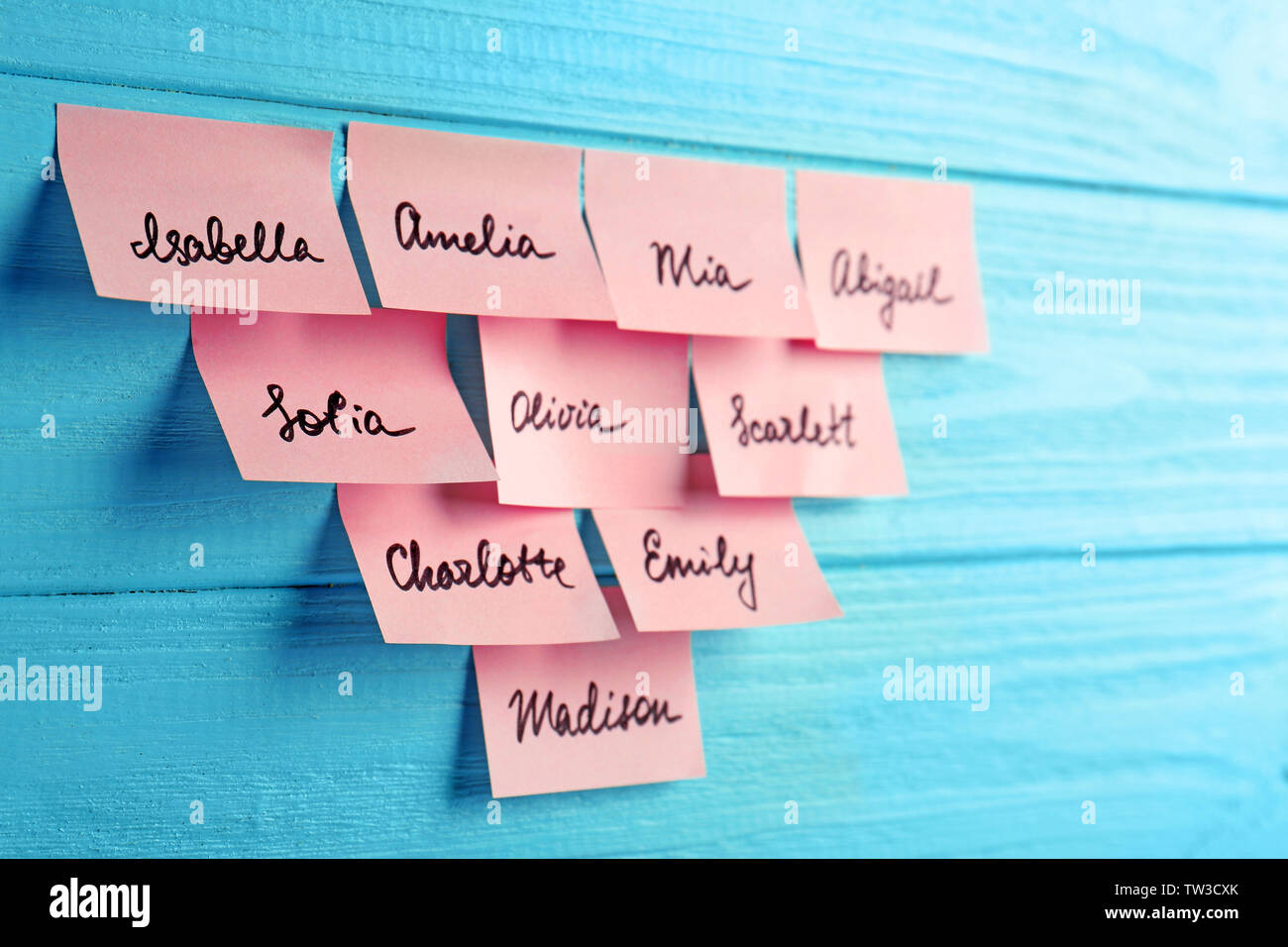 Paper stickers with different names on wooden background. Concept of ...