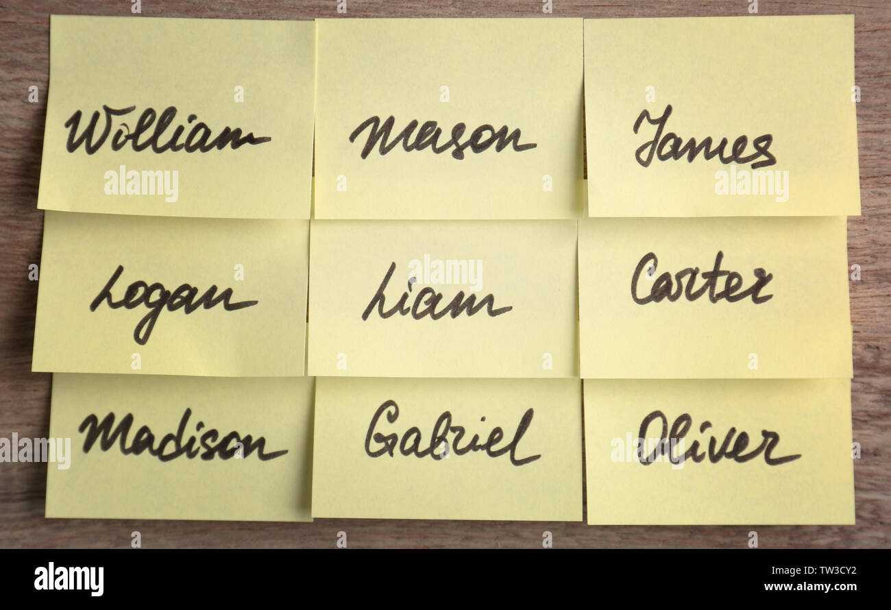Paper stickers with different names on wooden background. Concept of ...