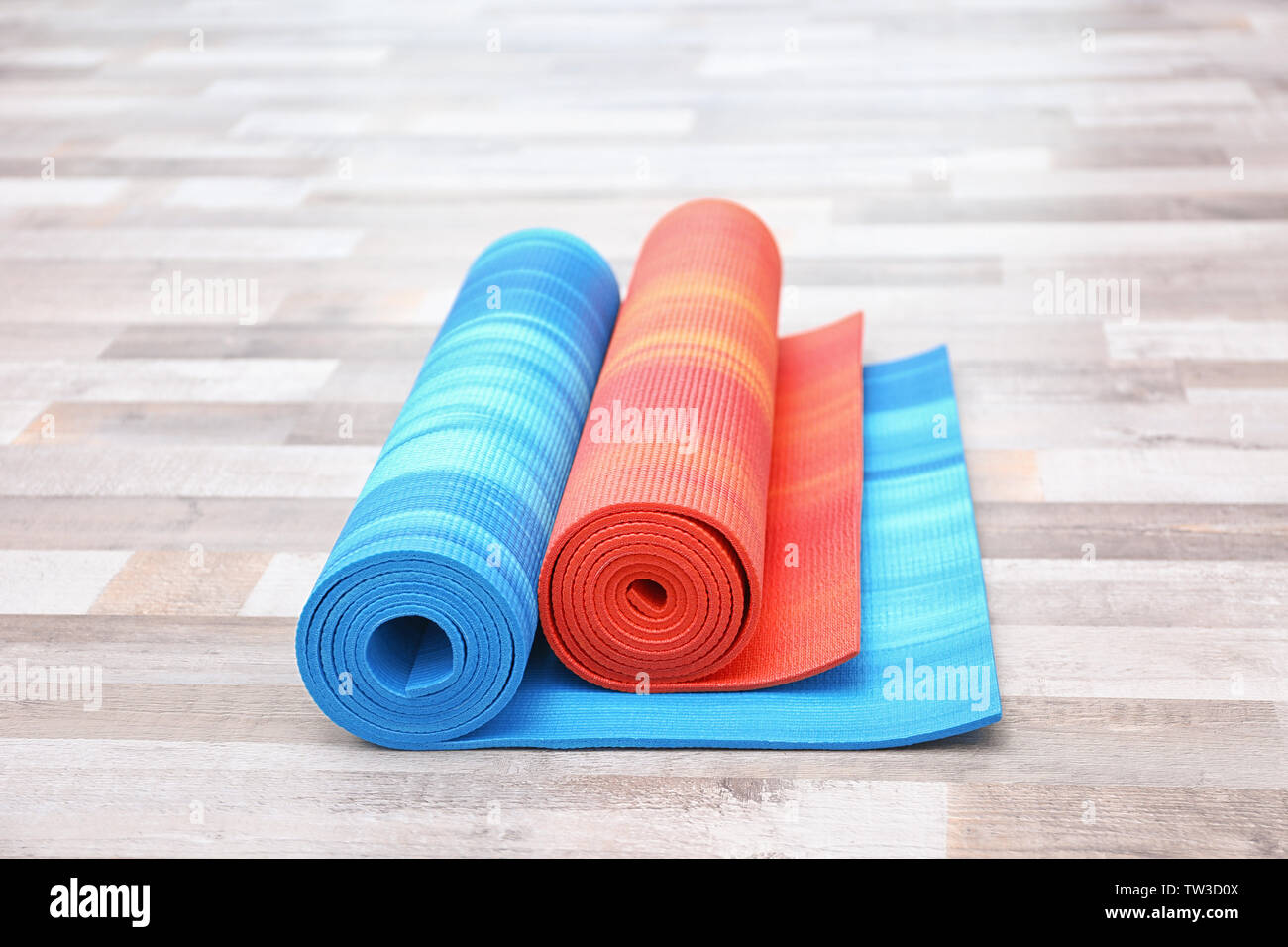 Two yoga mats on wooden floor Stock Photo - Alamy