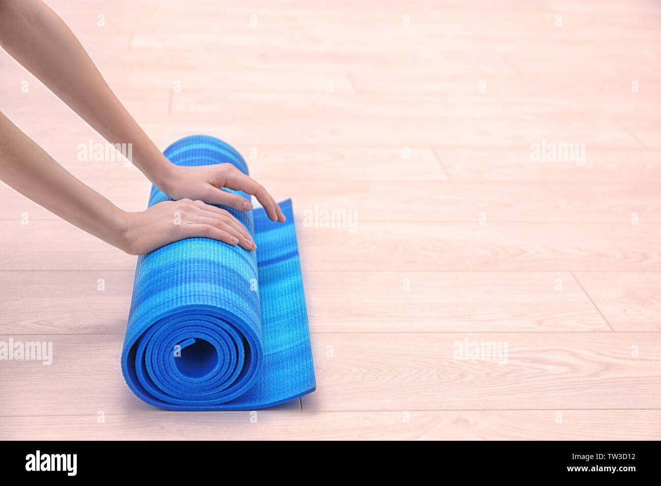 Rolling up yoga mat hi-res stock photography and images - Alamy