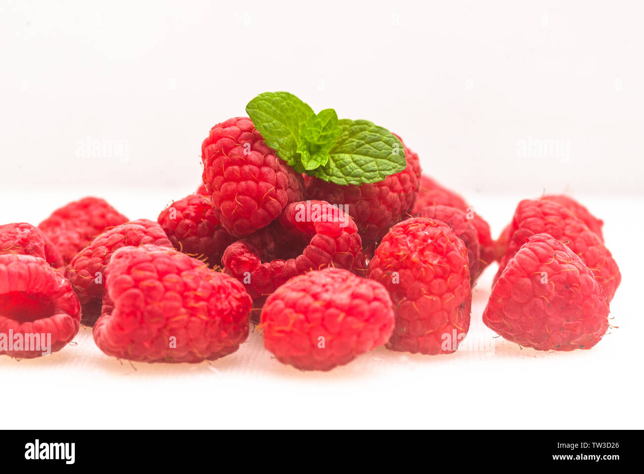 Fresh raspberries on white background Stock Photo - Alamy