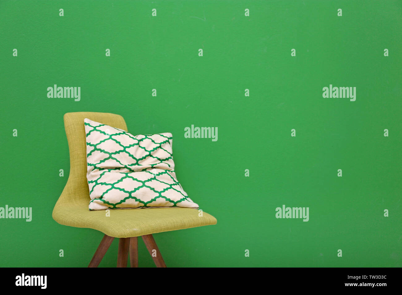 Cozy chair on green background Stock Photo - Alamy