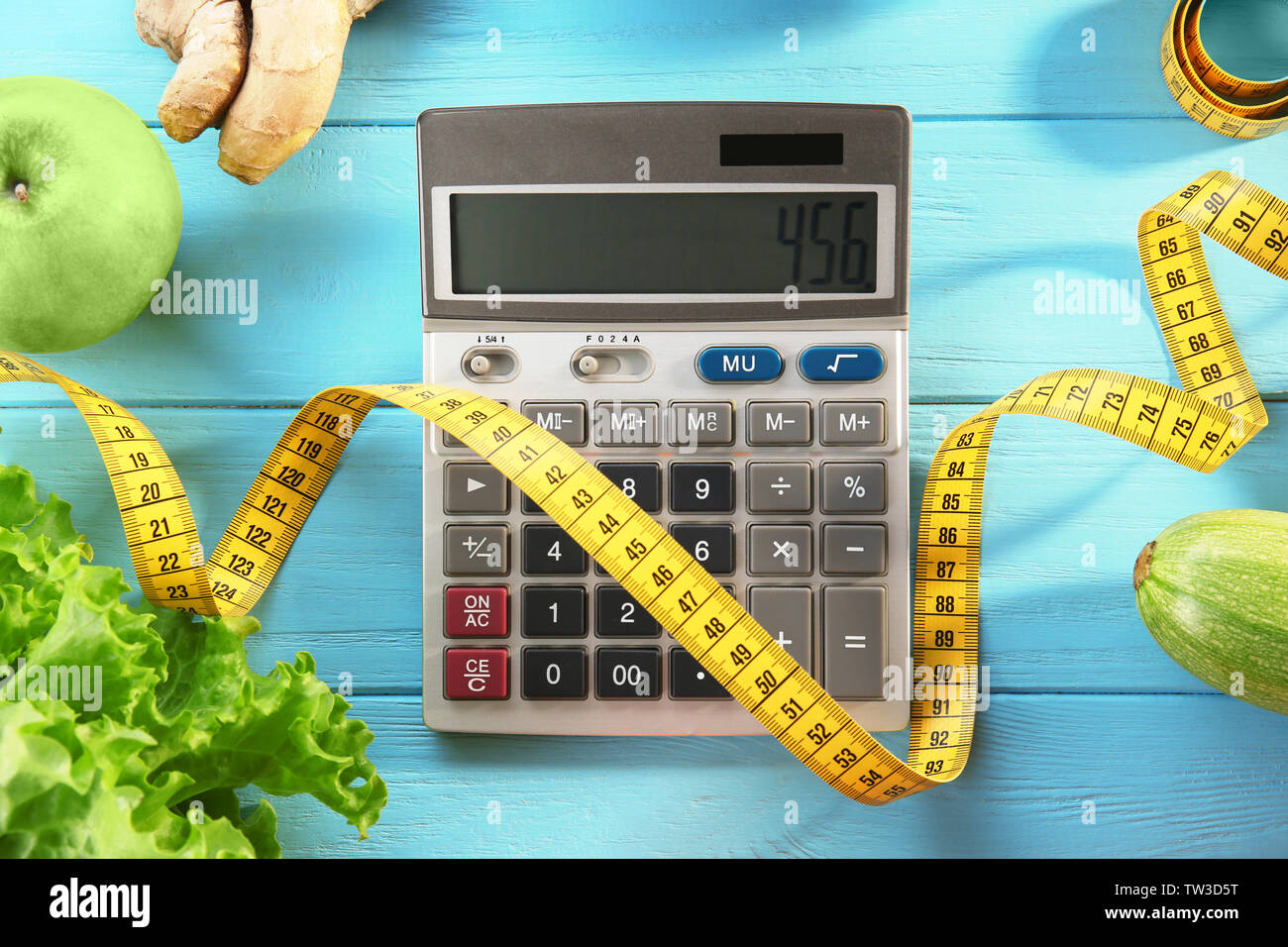 Diet concept. Calculator, measuring tape and different groceries on ...