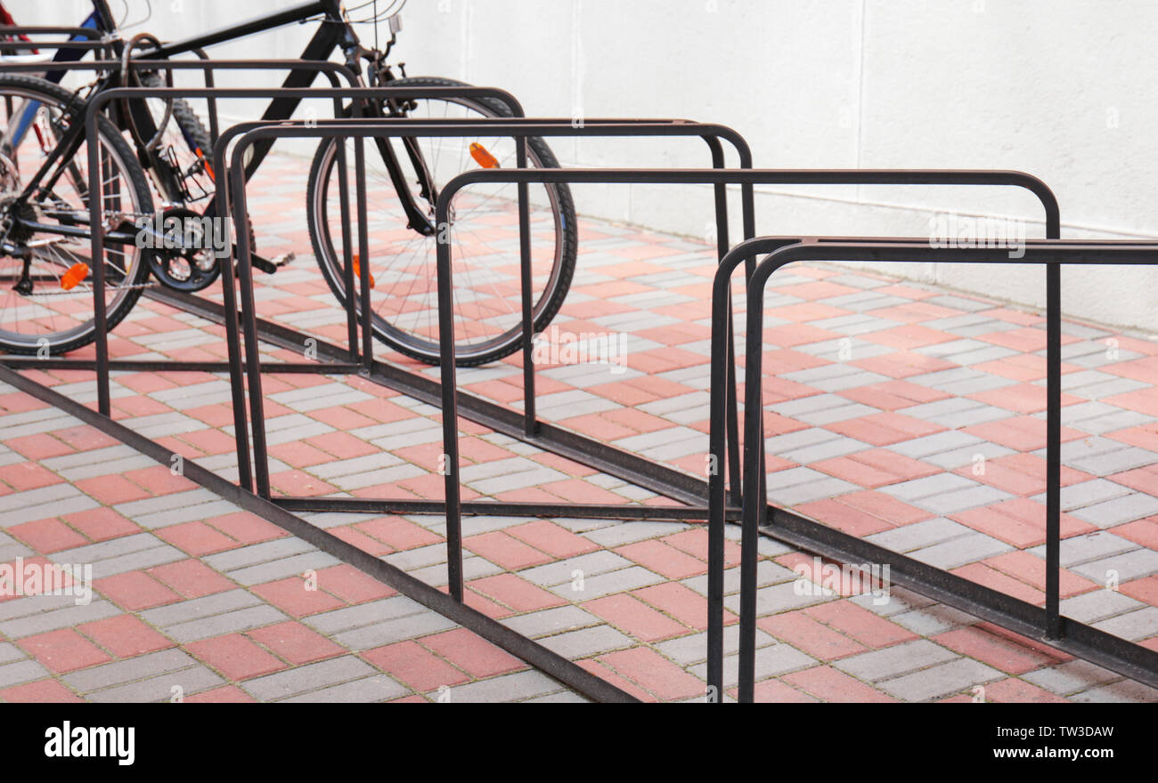 Bicycle rack with bikes on sidewalk Stock Photo - Alamy