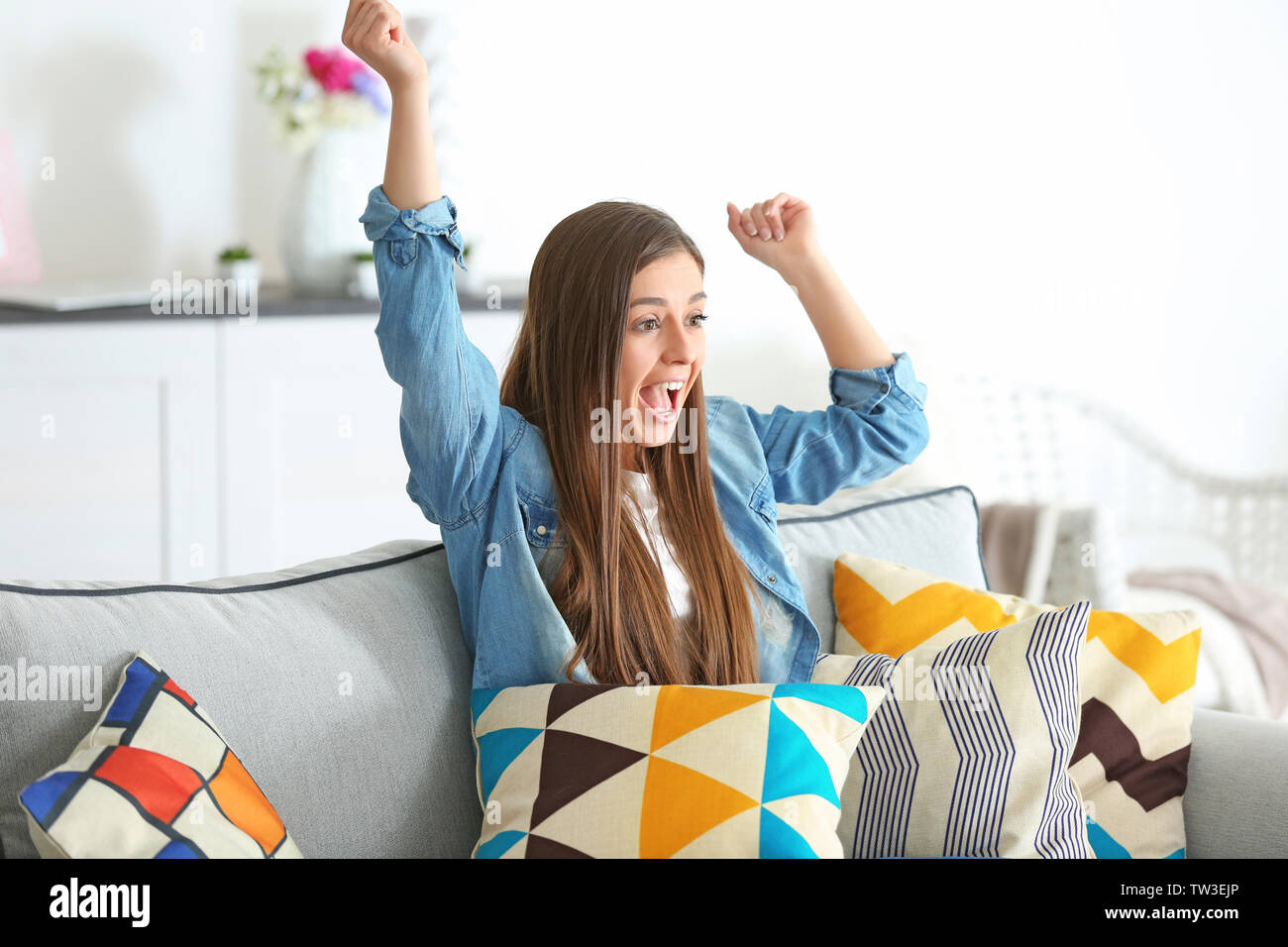 Beautiful woman watching TV at home Stock Photo - Alamy