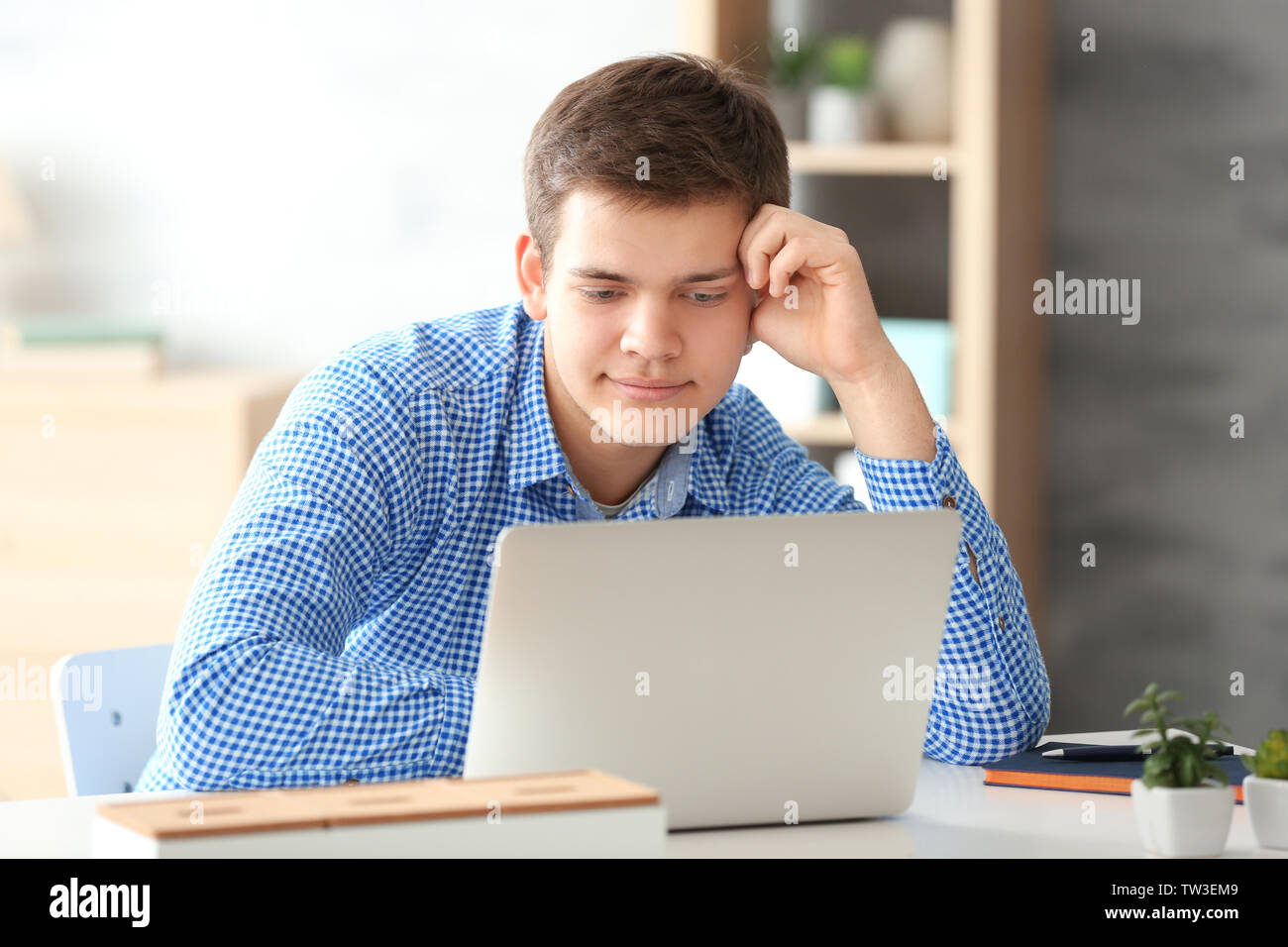 Handsome guy working on computer at home Stock Photo - Alamy