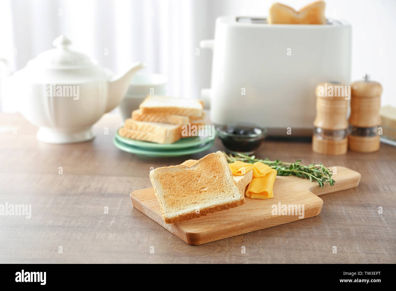 Wooden board with tasty breakfast toasts on table Stock Photo - Alamy