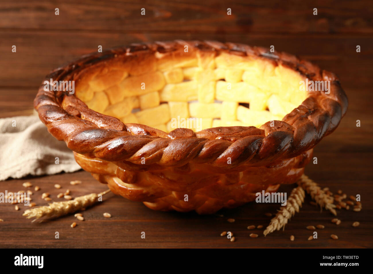 Delicious braided bread basket on table Stock Photo - Alamy