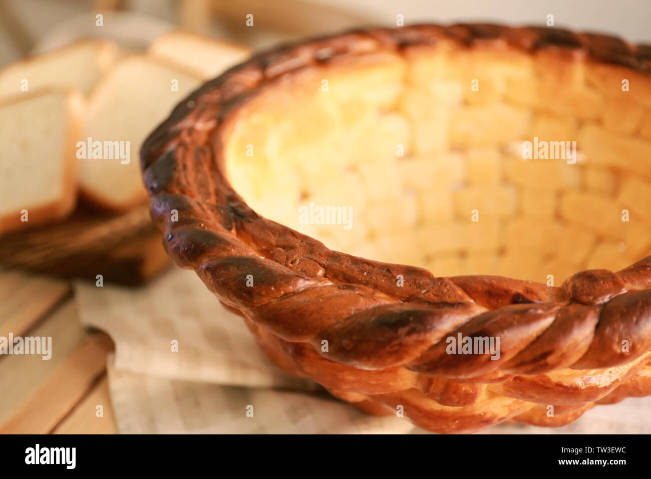 Delicious braided bread basket on table Stock Photo - Alamy