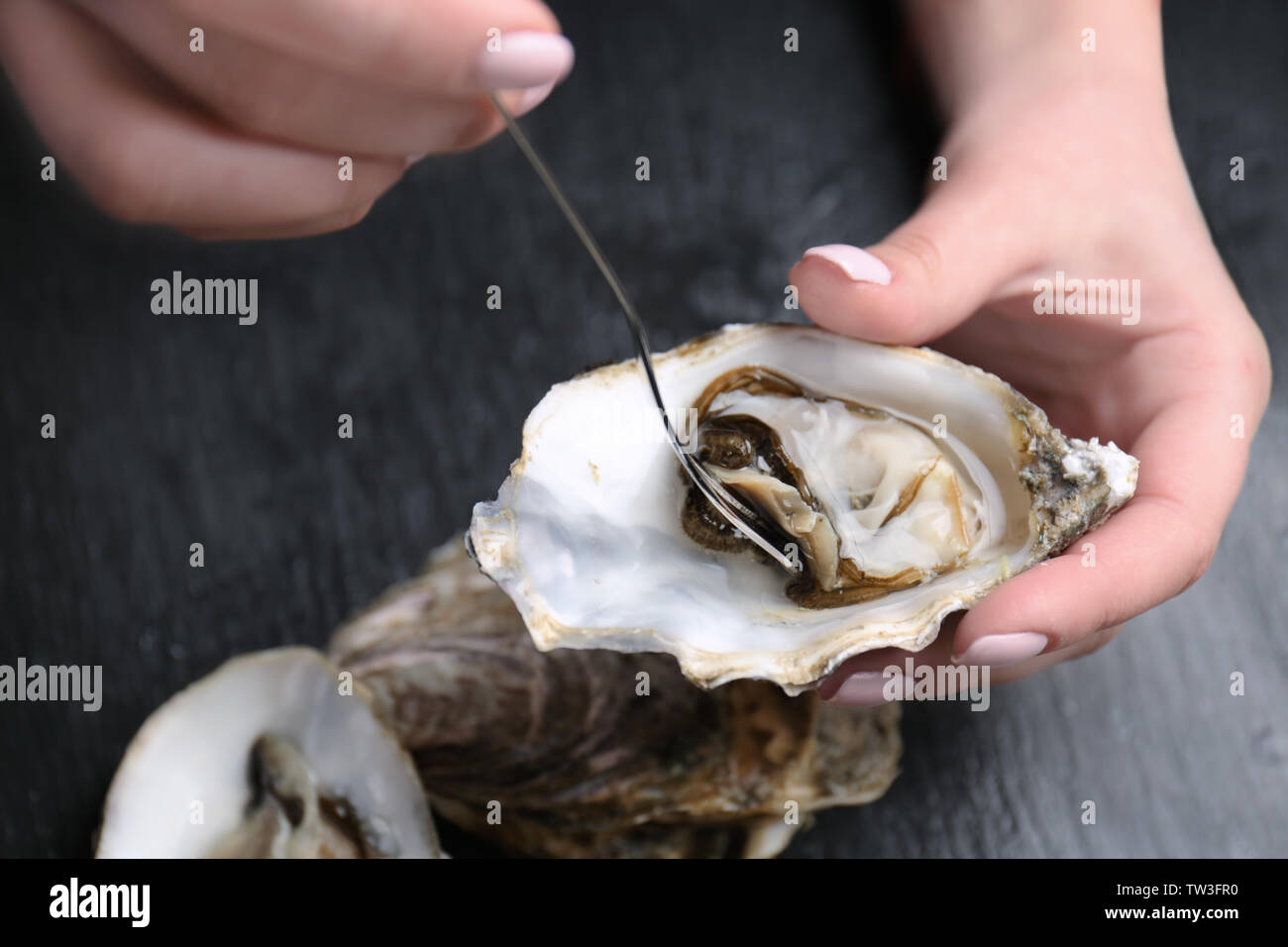 Eating seafood oyster table hands hi-res stock photography and images ...