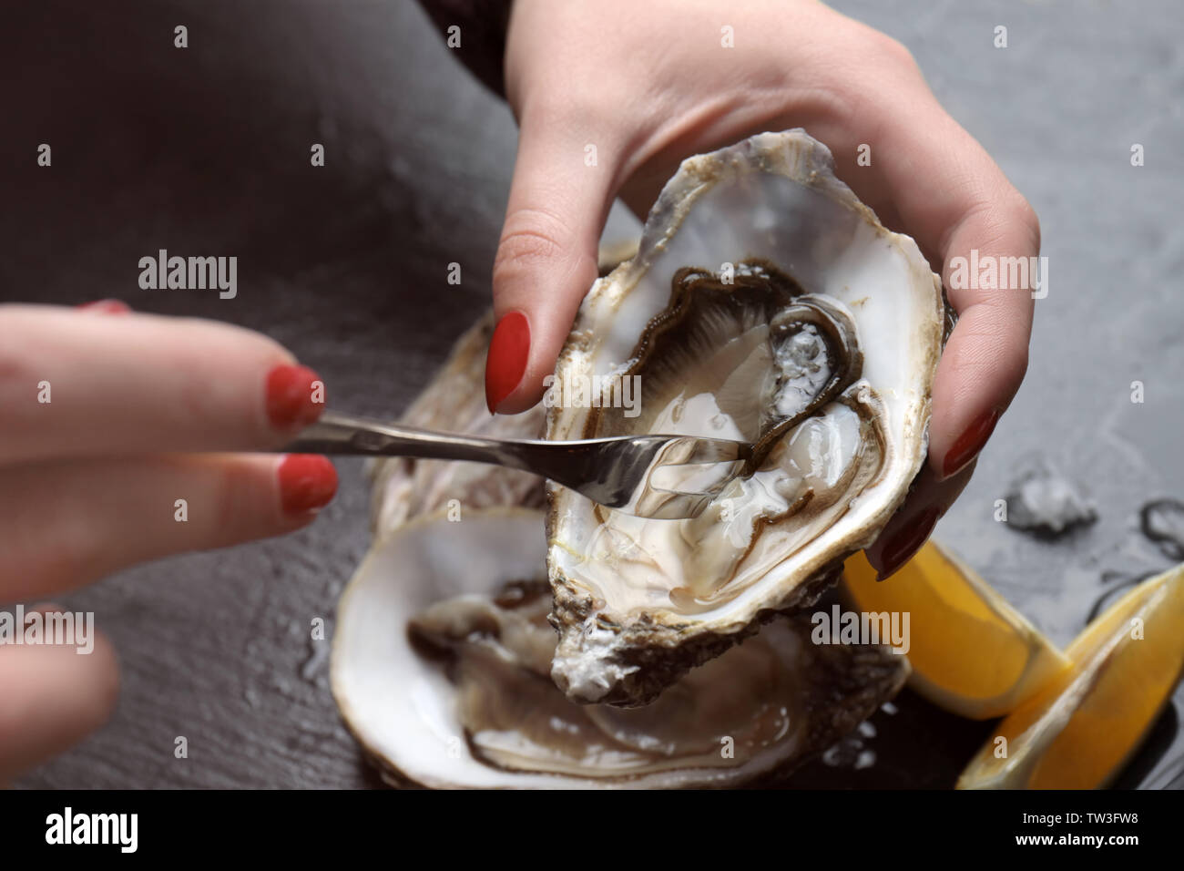 Eating seafood oyster table hands hi-res stock photography and images ...