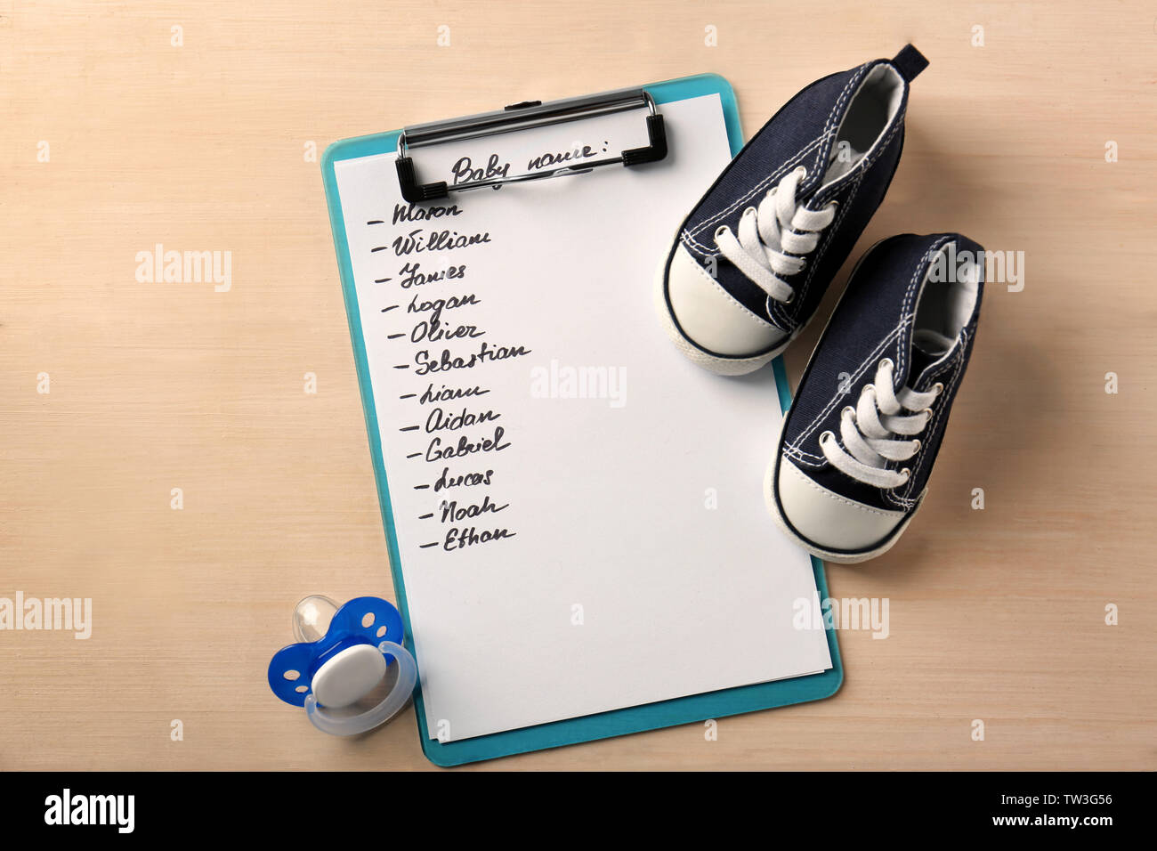 Composition with list of baby names on wooden background Stock Photo ...