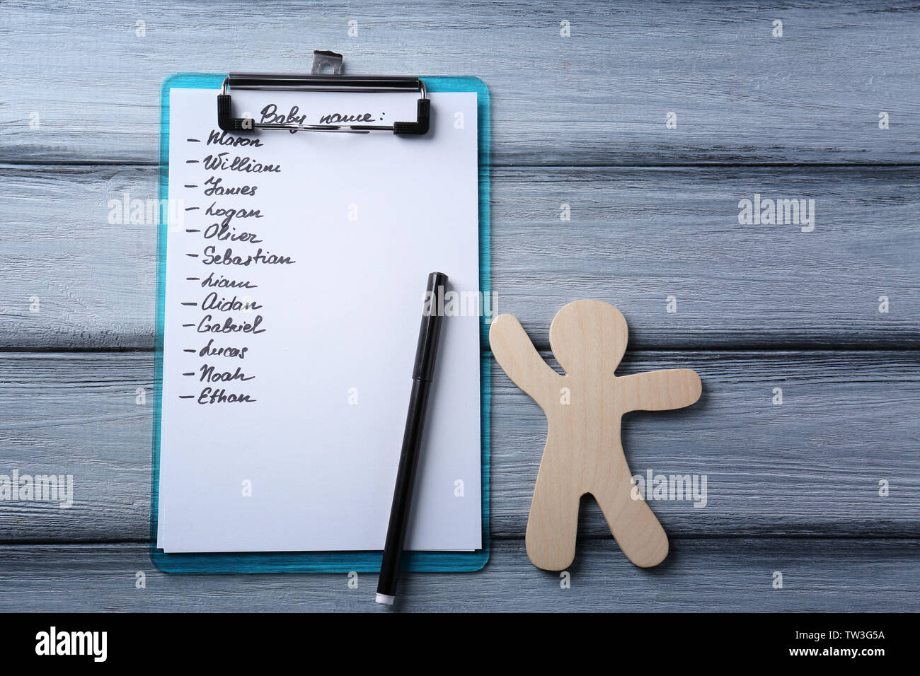 Clipboard with list of baby names on wooden background Stock Photo - Alamy