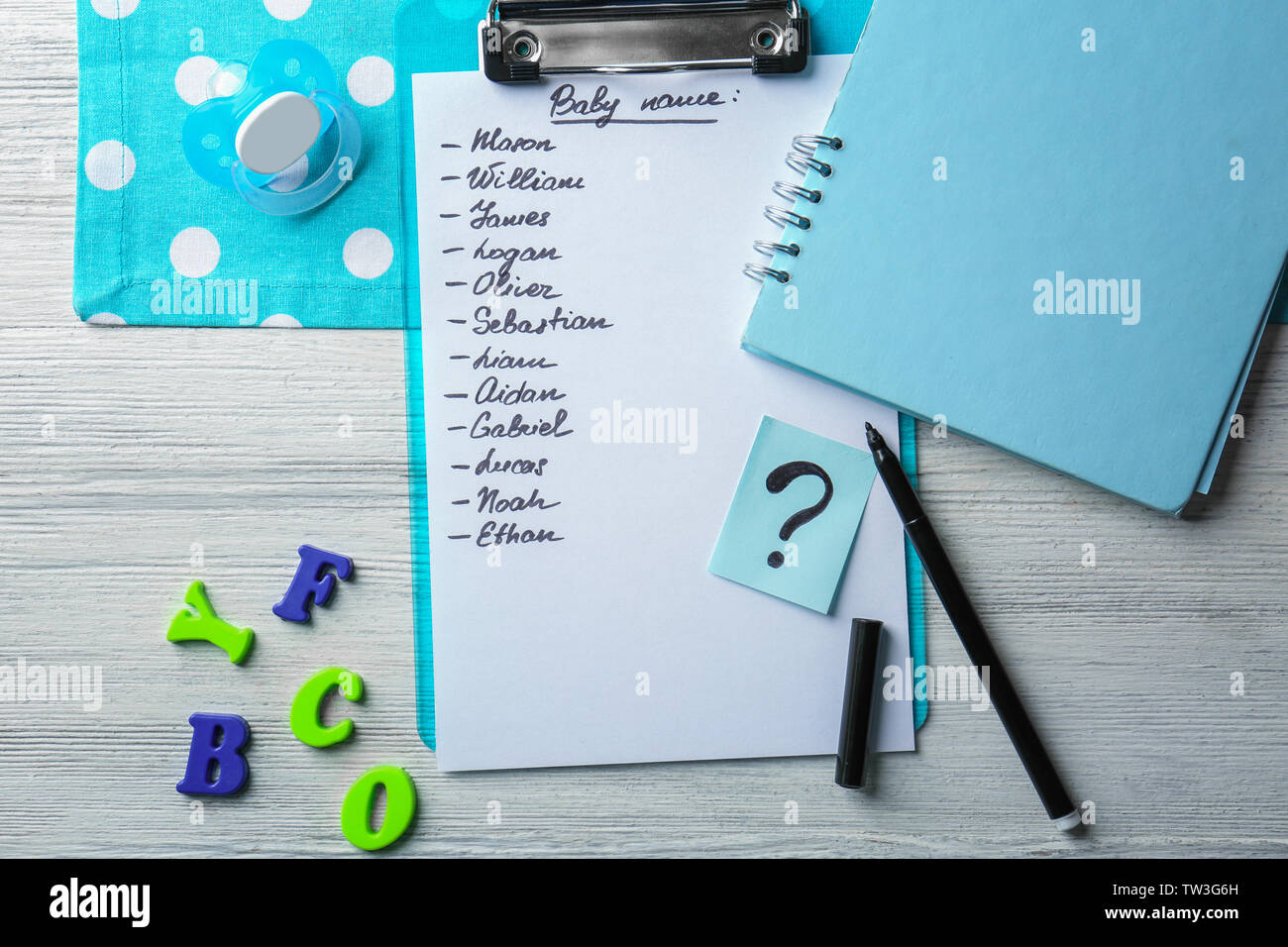 Composition with list of baby names on wooden background Stock Photo ...