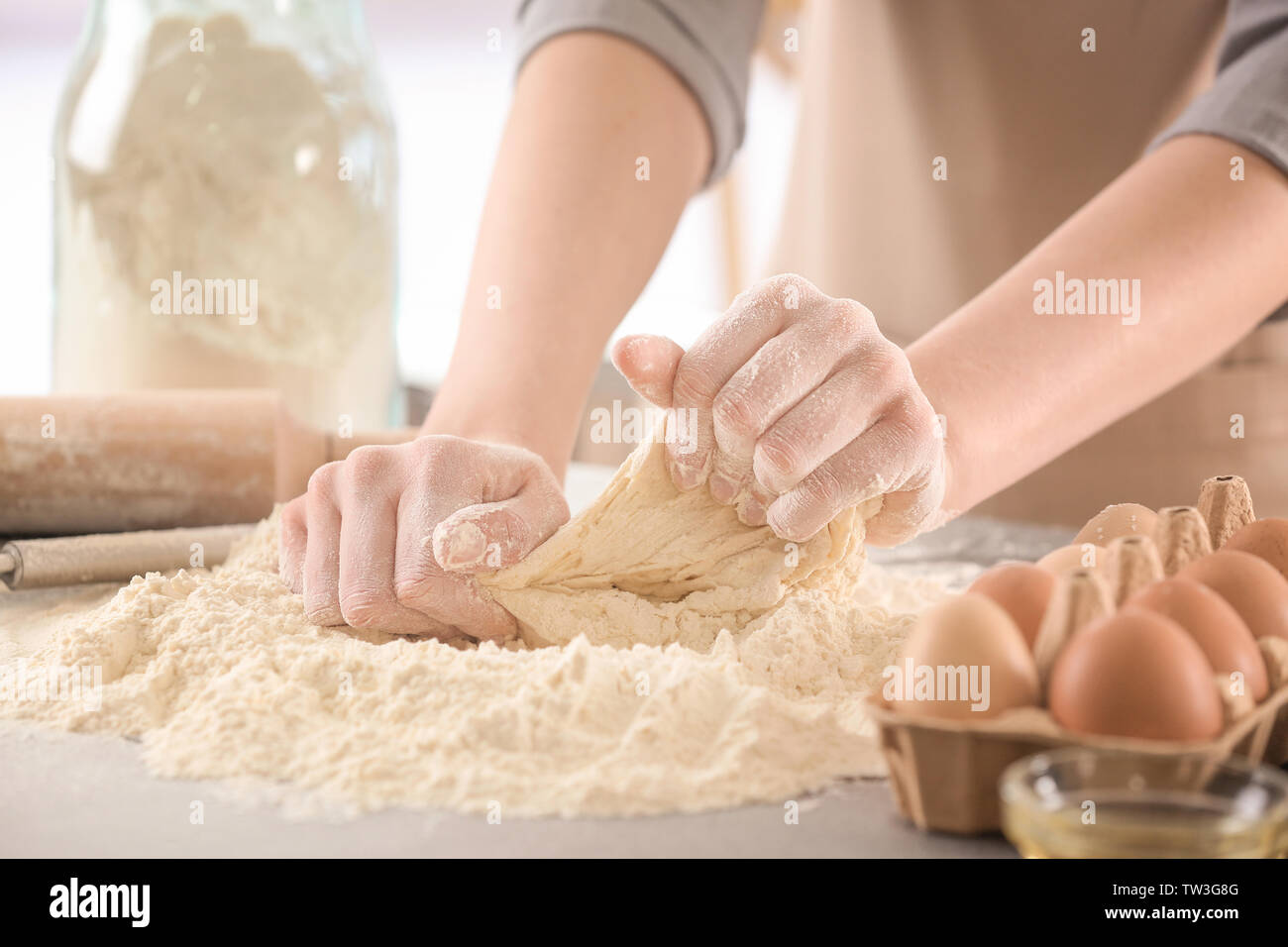 Female chef making dough in kitchen Stock Photo - Alamy