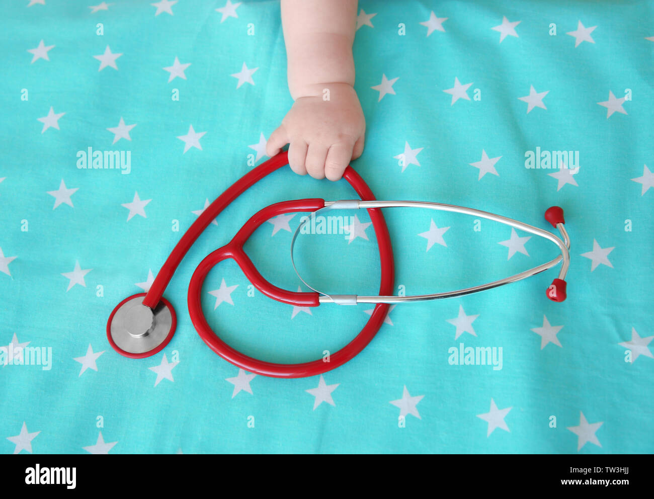 Baby hand and stethoscope on bedsheet. Baby health concept Stock Photo ...