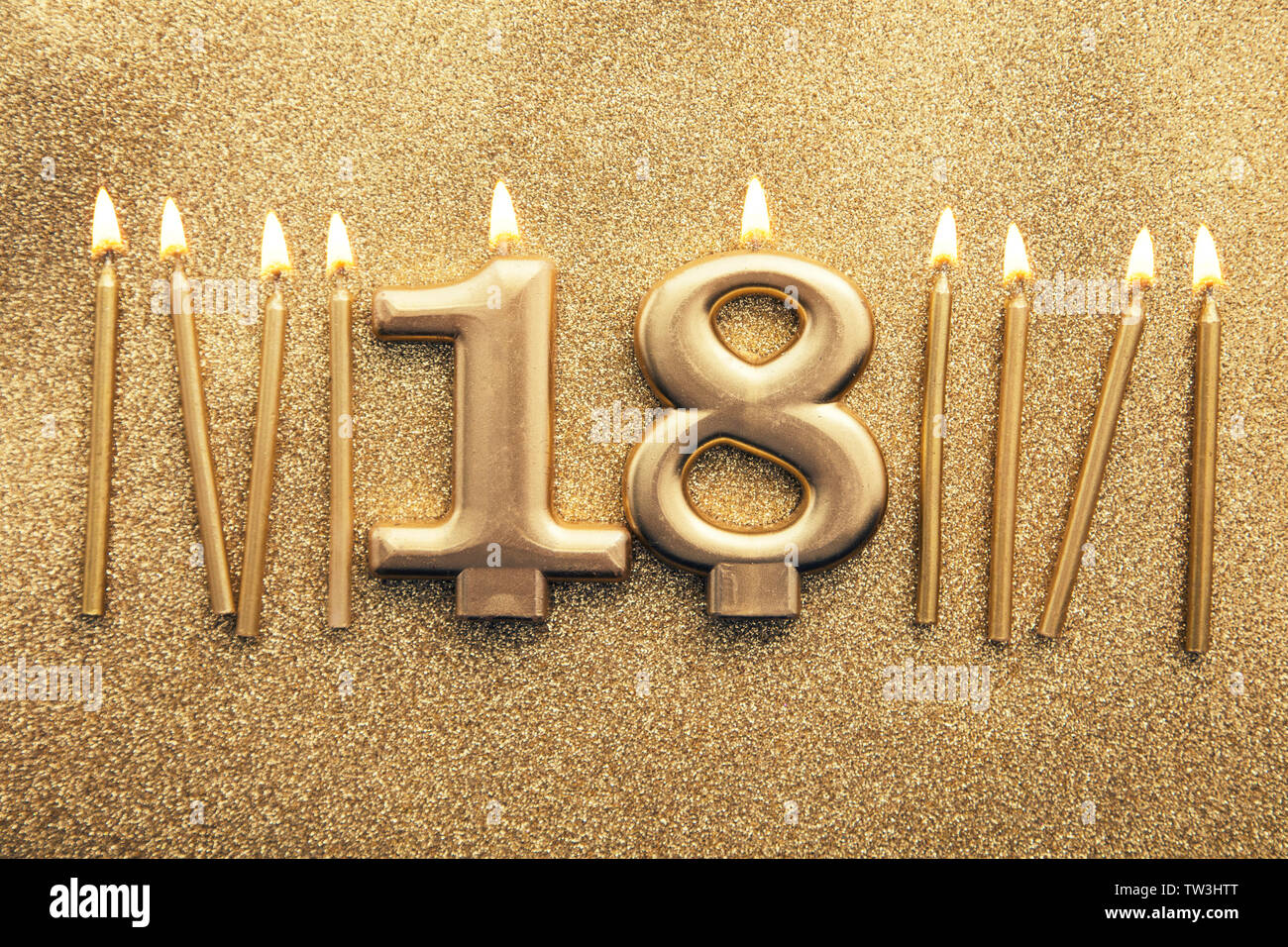 Number 18 gold celebration candle on a glitter background Stock Photo ...