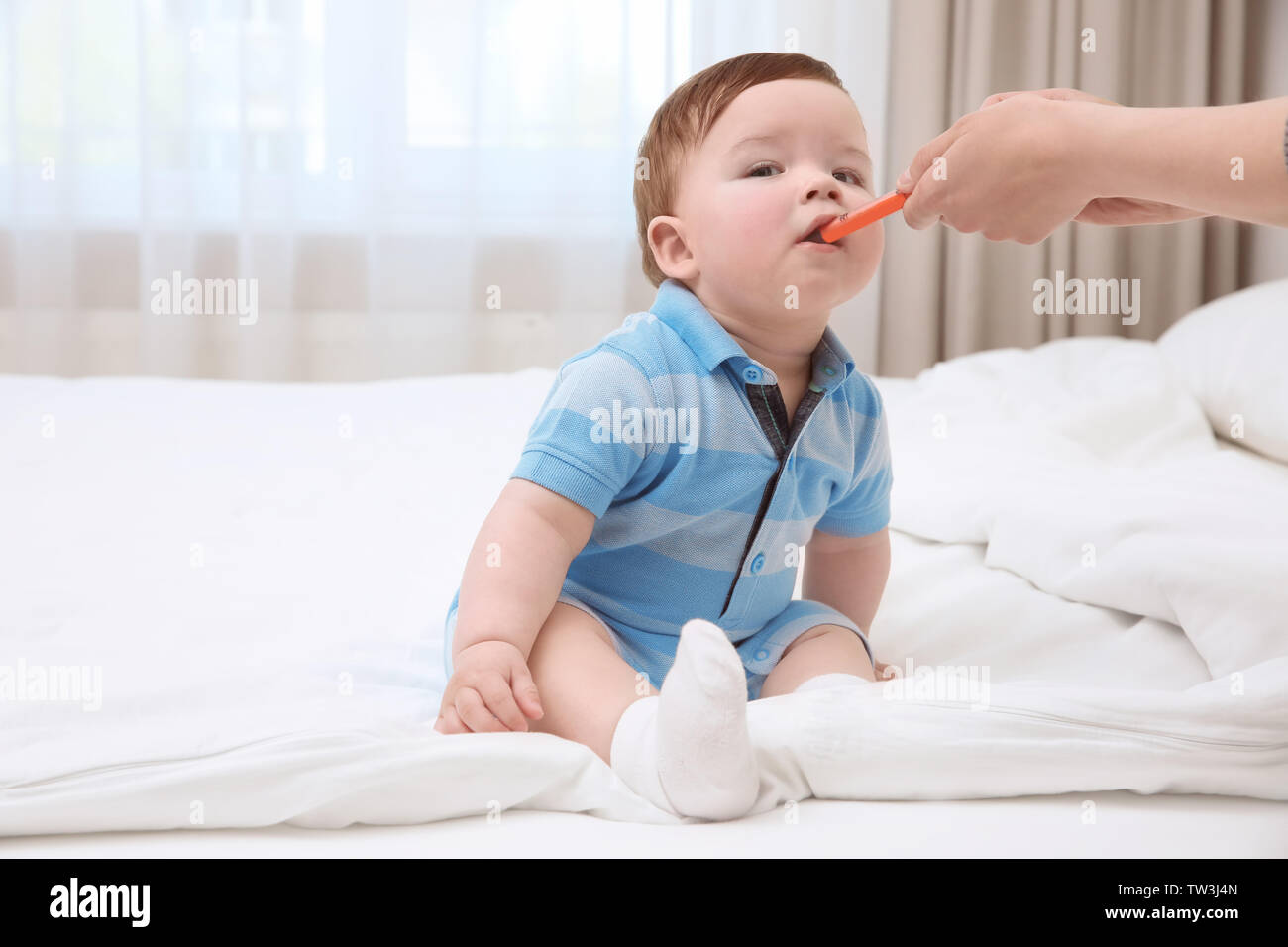 Health care concept. Woman giving medicine to sick little baby indoors ...