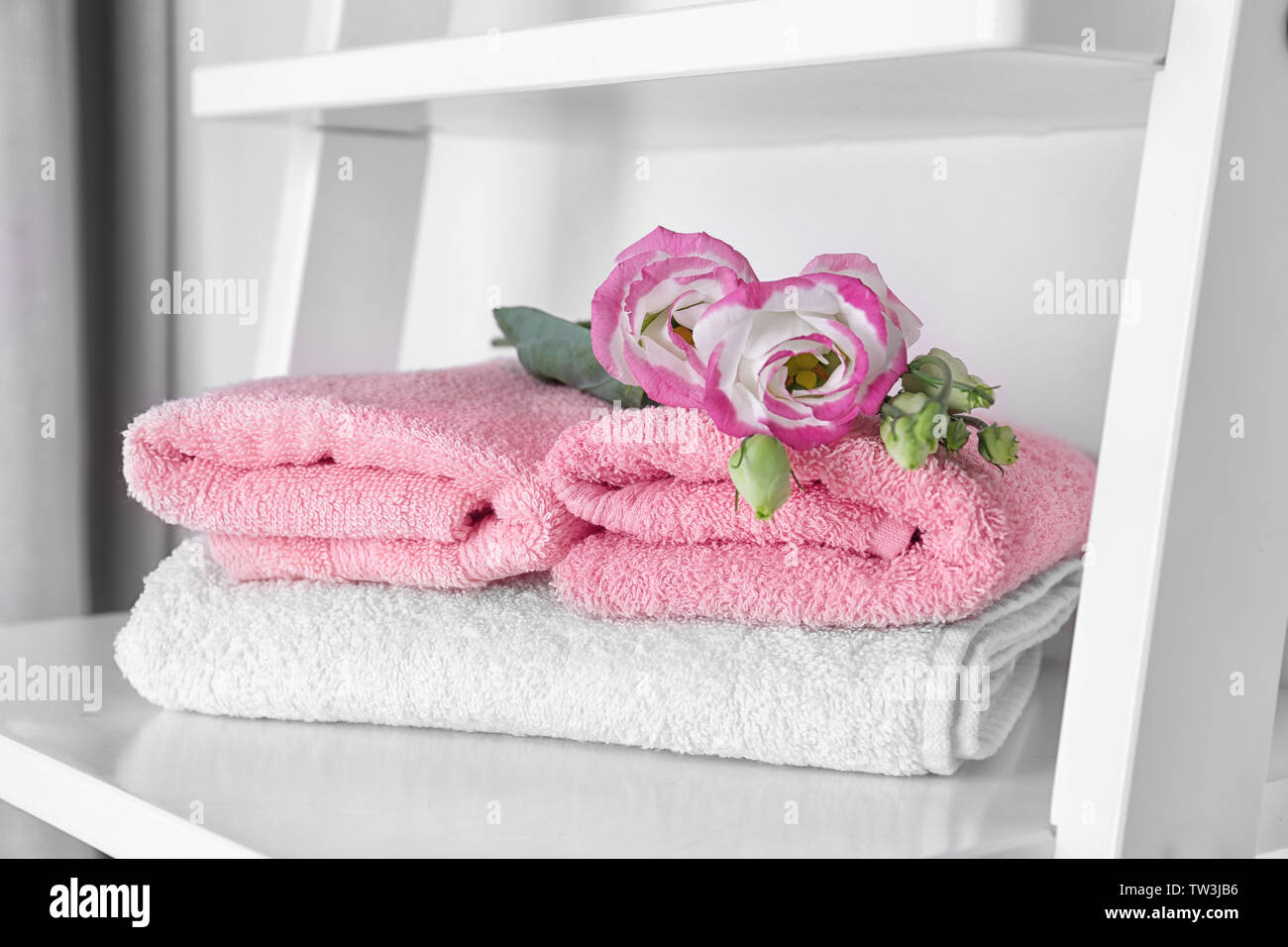 Stack of clean towels on shelf Stock Photo - Alamy