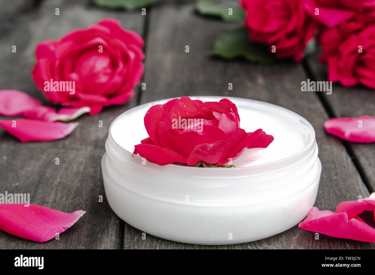 Natural flower cosmetics with red pink flowers for face and body care ...