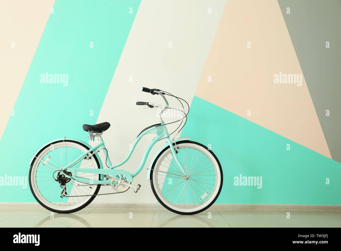 Modern two-wheeled bicycle indoors near color wall Stock Photo - Alamy