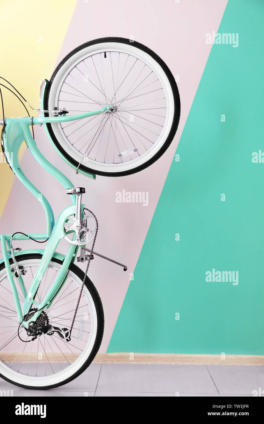 Modern two-wheeled bicycle indoors near color wall Stock Photo - Alamy