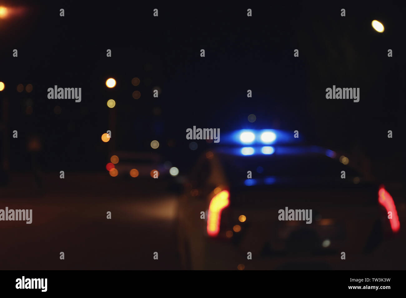 Blurred view of police car on road at night Stock Photo - Alamy