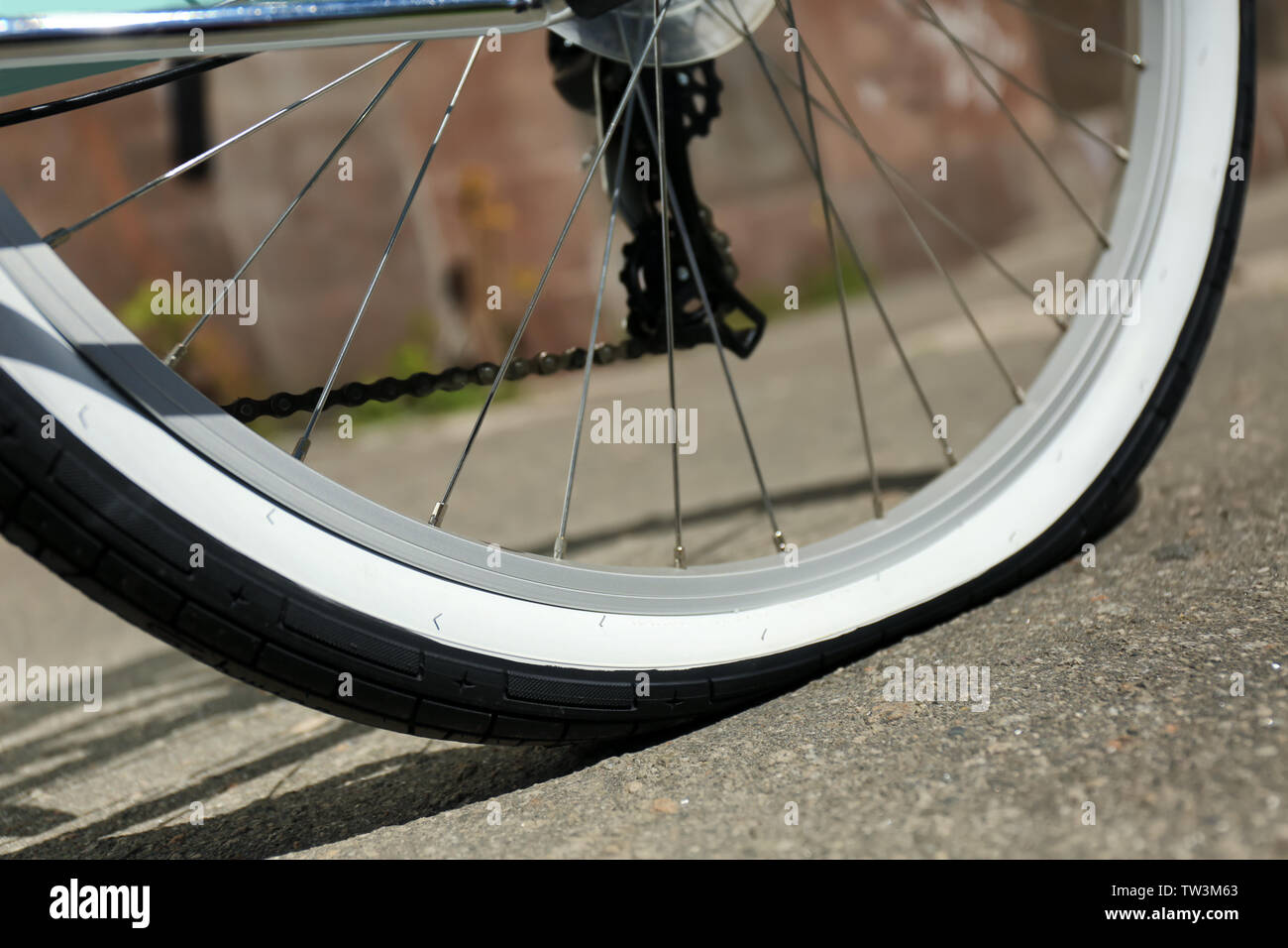 Closeup view of bicycle flat tire on pavement Stock Photo - Alamy