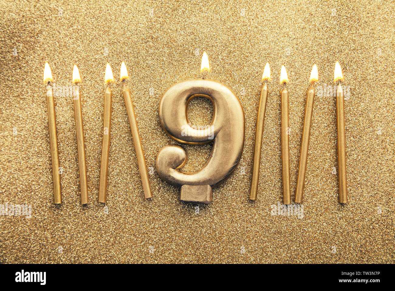 Number 9 gold celebration candle on a glitter background Stock Photo ...