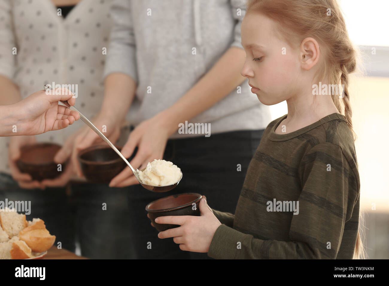 Woman distributing food to poor and homeless people Stock Photo - Alamy