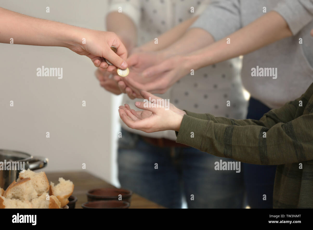 Woman donating money to poor and homeless people Stock Photo - Alamy
