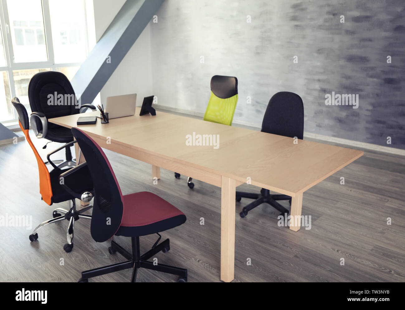 Wooden table with chairs in office Stock Photo - Alamy