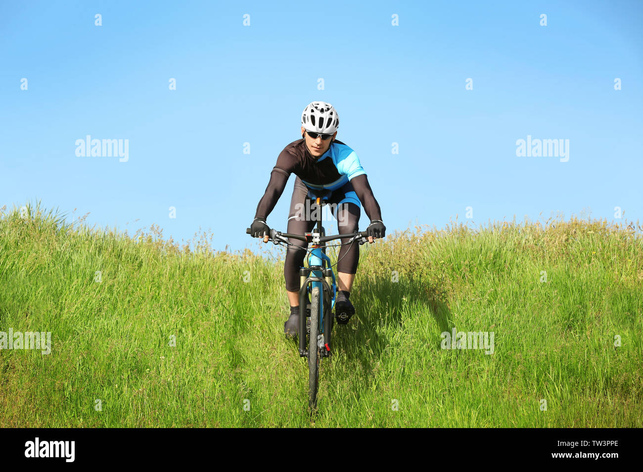 Sporty cyclist riding bicycle in countryside Stock Photo - Alamy